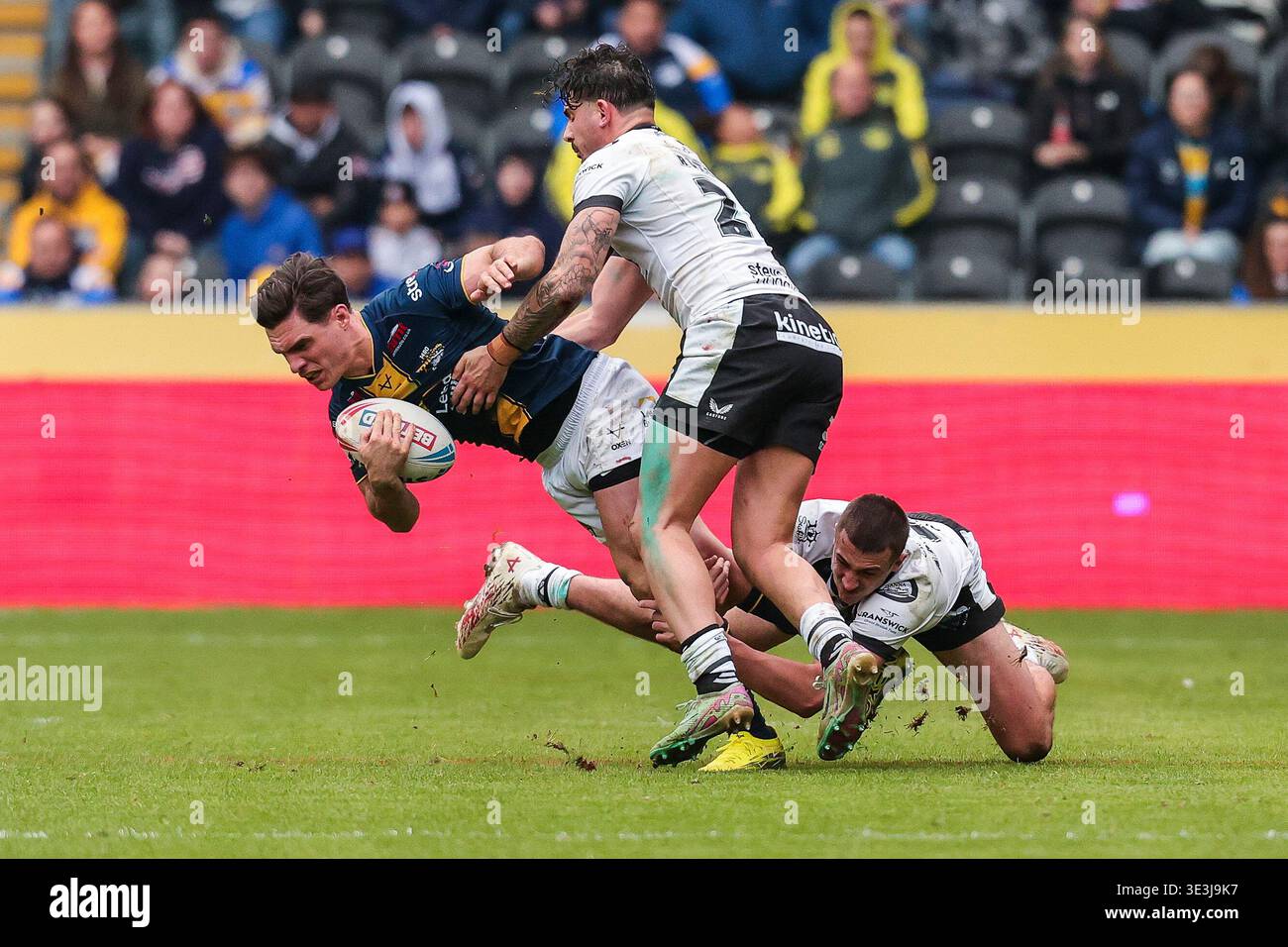 Brodie Croft of Leeds Rhinos is tackled by Jake Arthur of Hull FC ...