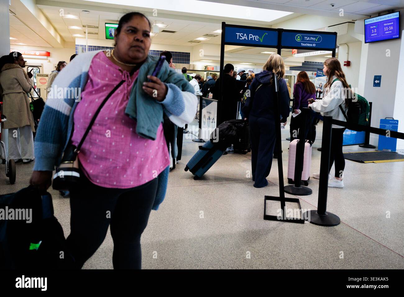 People walk through Philadelphia International Airport, Monday, March ...