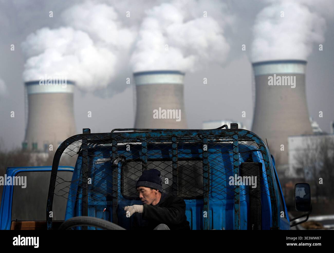 FILE - A worker throws his cigarette on a truck parked in front of a ...