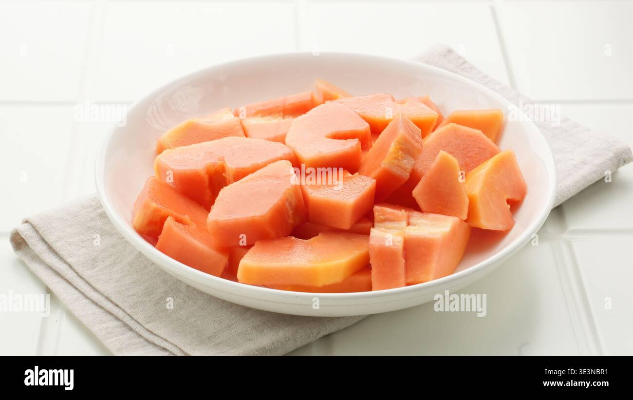 Healthy and fresh cut papaya fruit or sliced papaya, served in a white ...