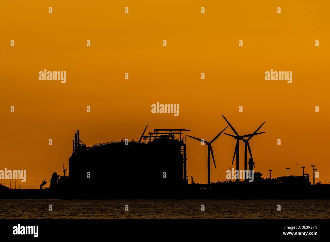 At sunset, a view of the petrochemical complex and the oil port from ...