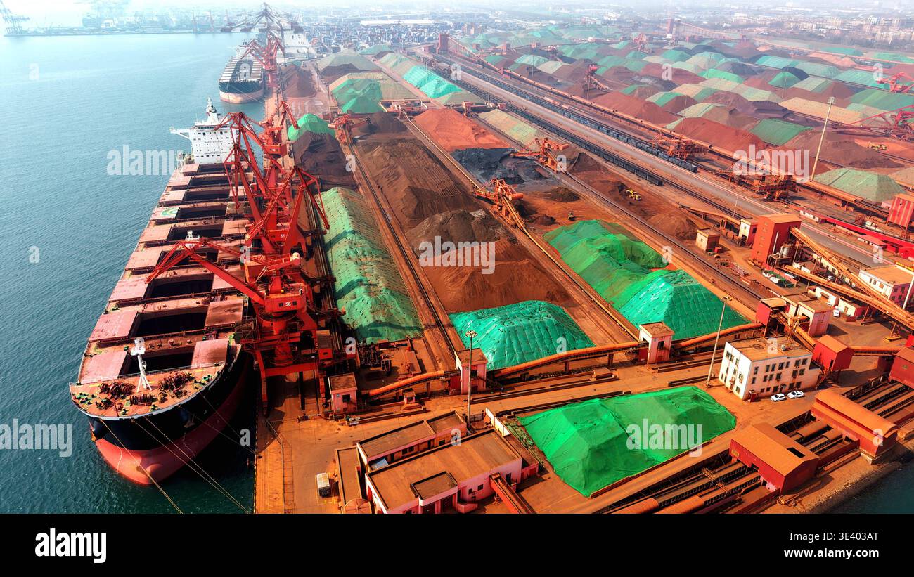 A cargo ship unloads imported iron ore at the Qingdao Port Ore Terminal ...