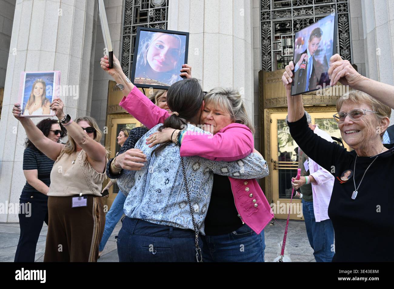 Lori Schott, center right, embraces Mary Rodee after the verdict in a ...