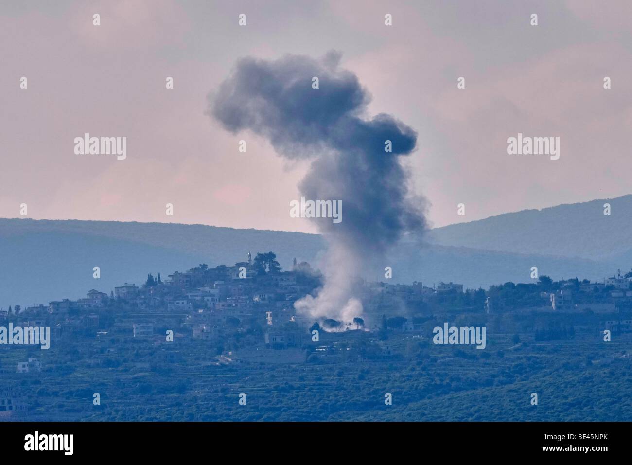 Smoke rises from an Israeli airstrike that hit Zibbikin village as seen ...