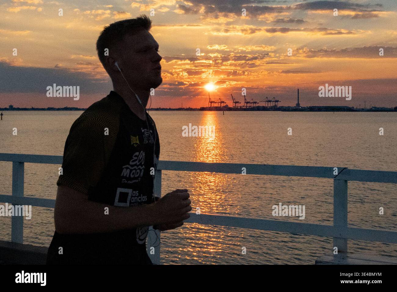 A runner exercising during sunset time at Kerferd Road Pier on March 22 ...