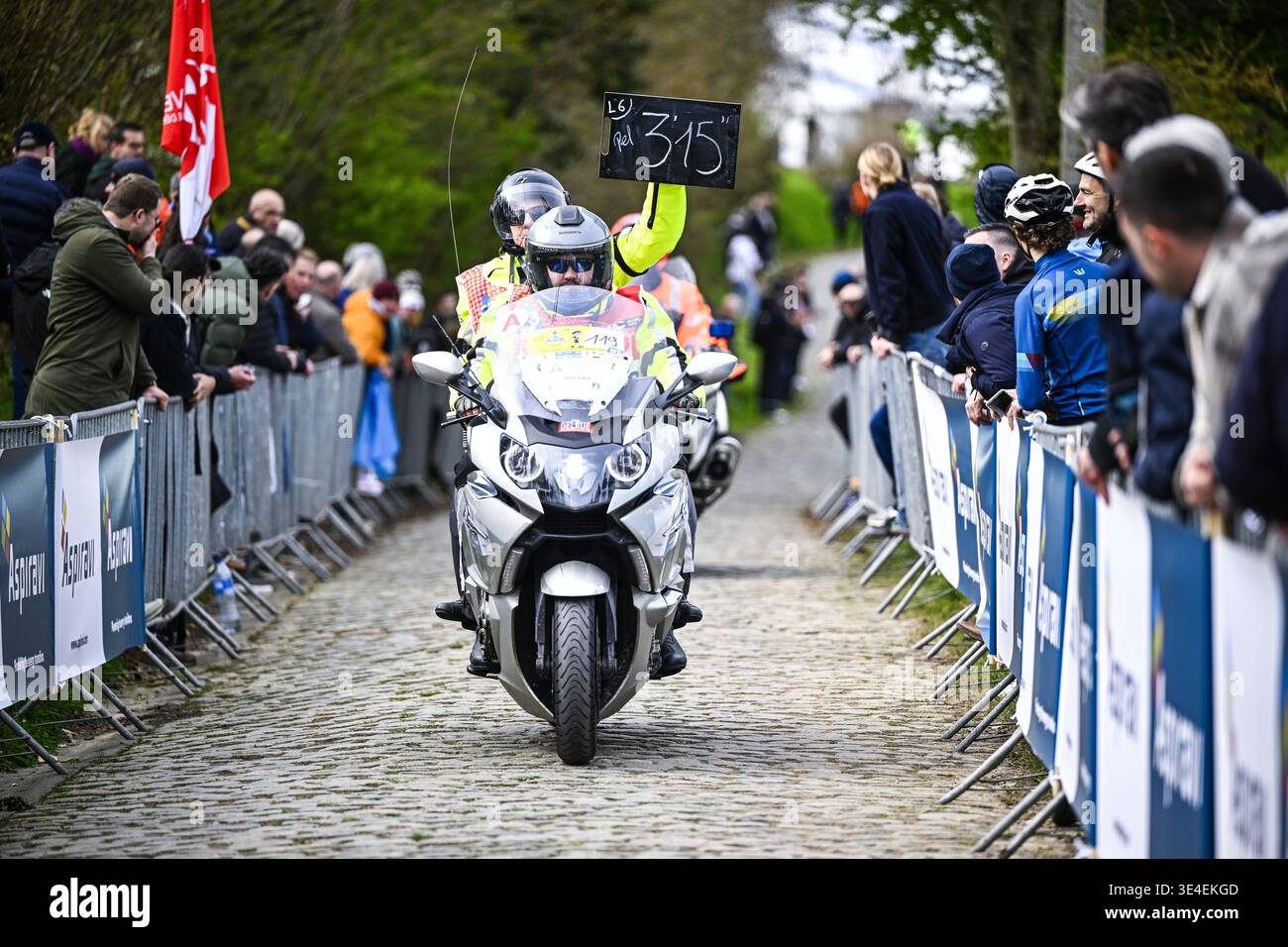 Motorcyclist giving the split time during the 'E3 Saxo Bank Classic ...