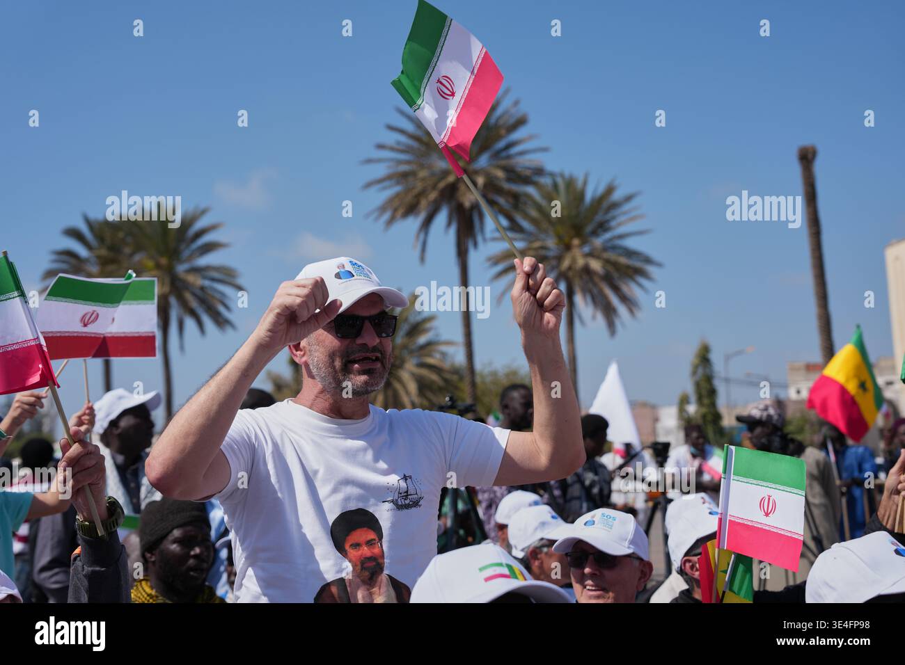 A protester waves an Iranian flag at an anti-war solidarity protest in ...
