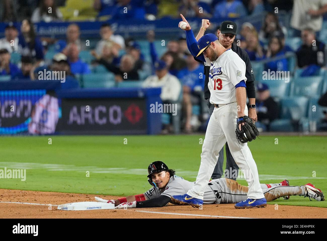 Los Angeles Dodgers third baseman Max Muncy (13) reacts after tagging ...