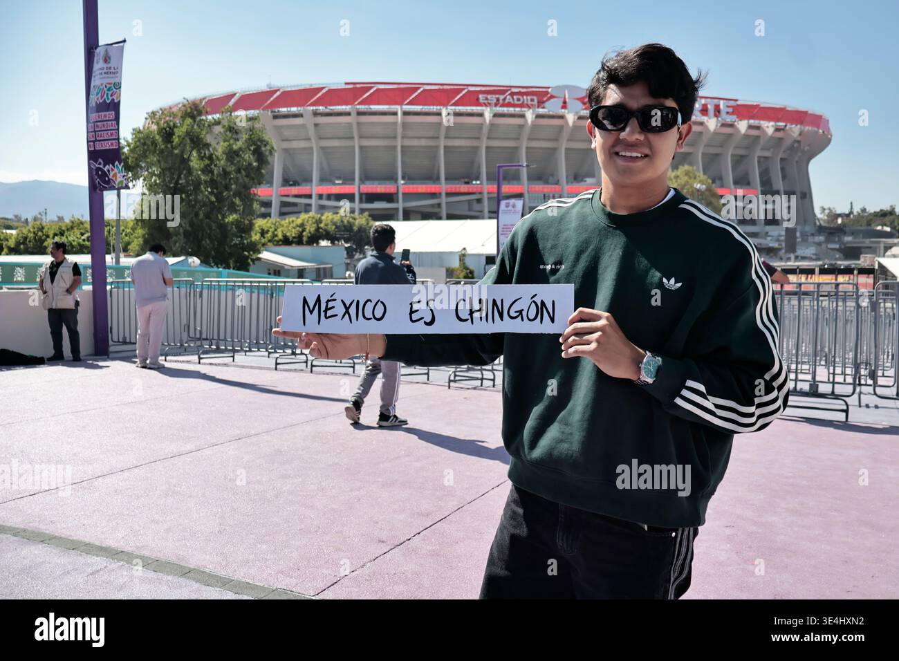 A young man holds a poster with the phrase "Mexico is awesome" on the ...