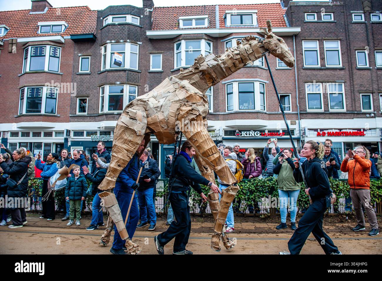 A giraffe seen moving with the help of three puppeteers. THE HERDS, a ...