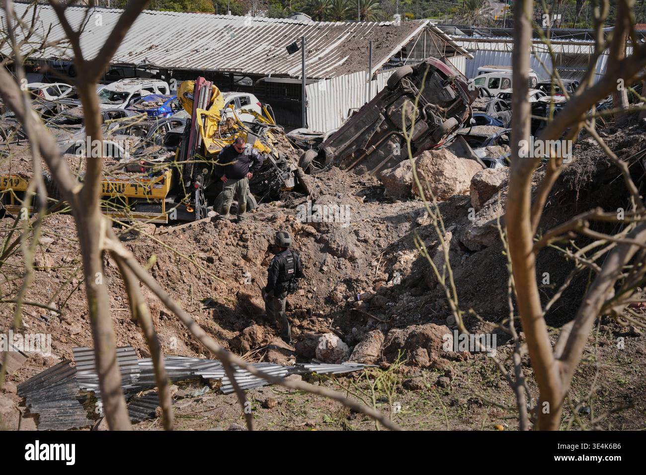 Israeli security forces examine the site of an Iranian missile strike ...