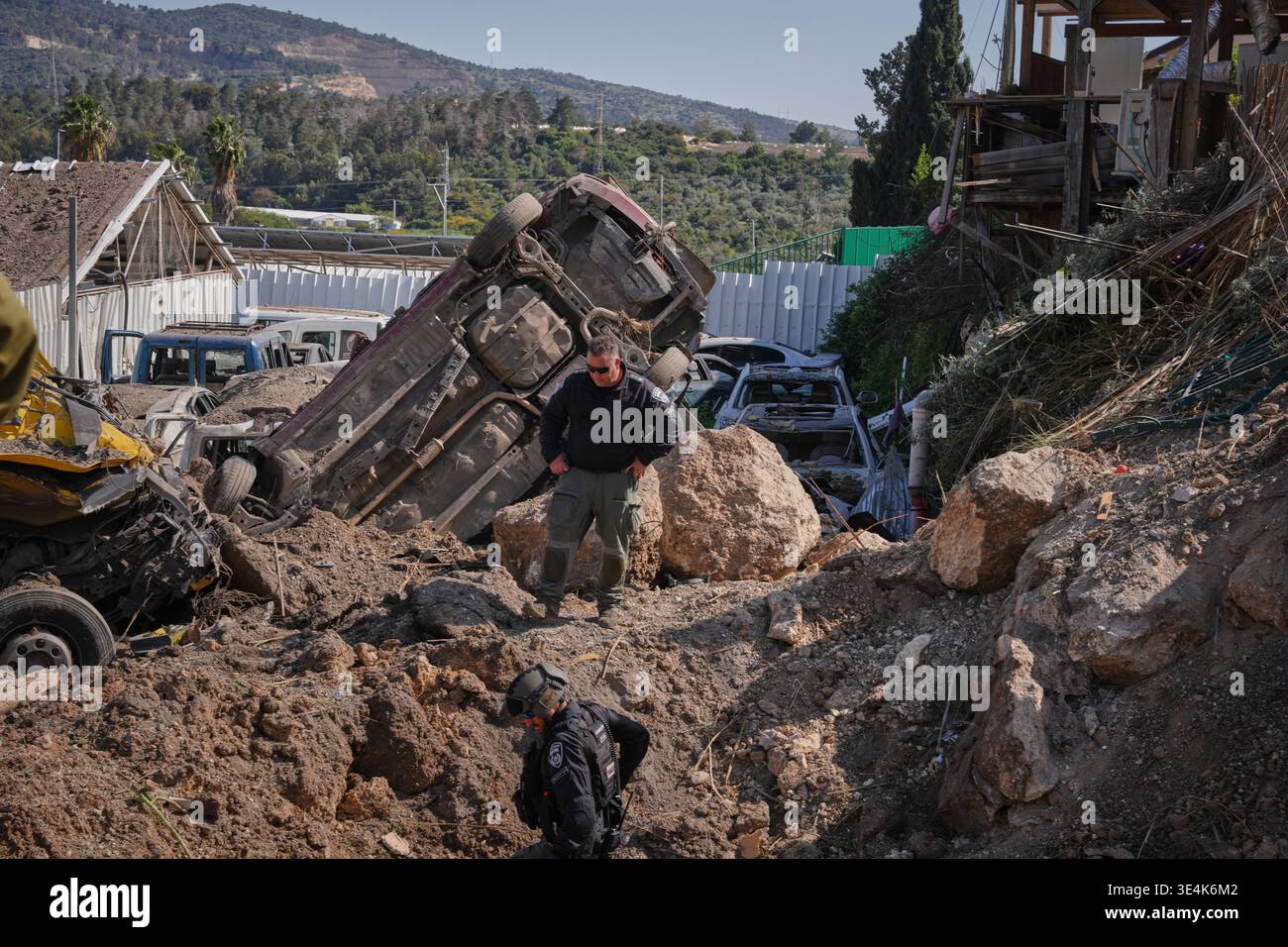 Israeli security forces examine the site of an Iranian missile strike ...