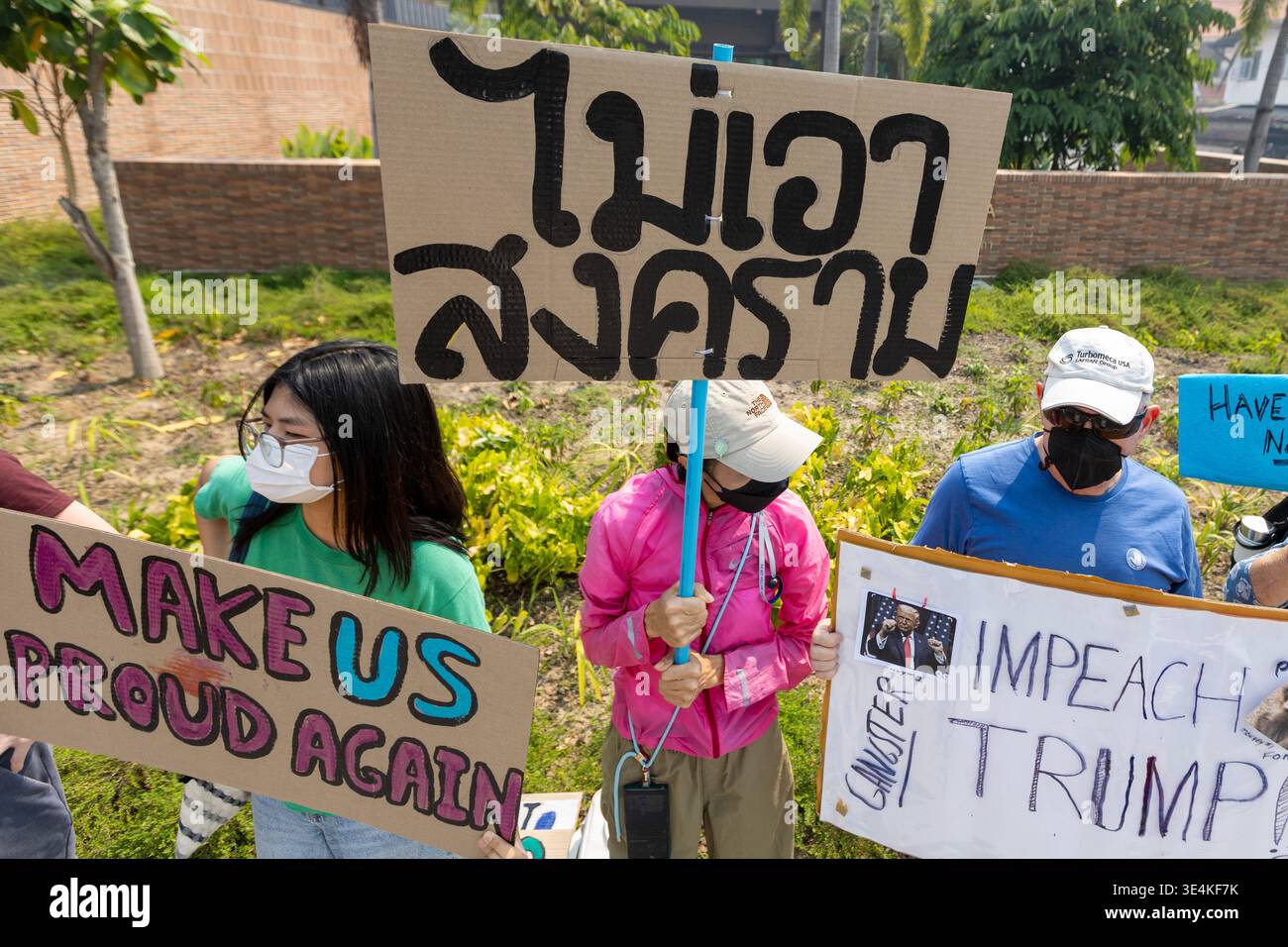 Anti-war protesters hold handmade placards expressing their opinions ...