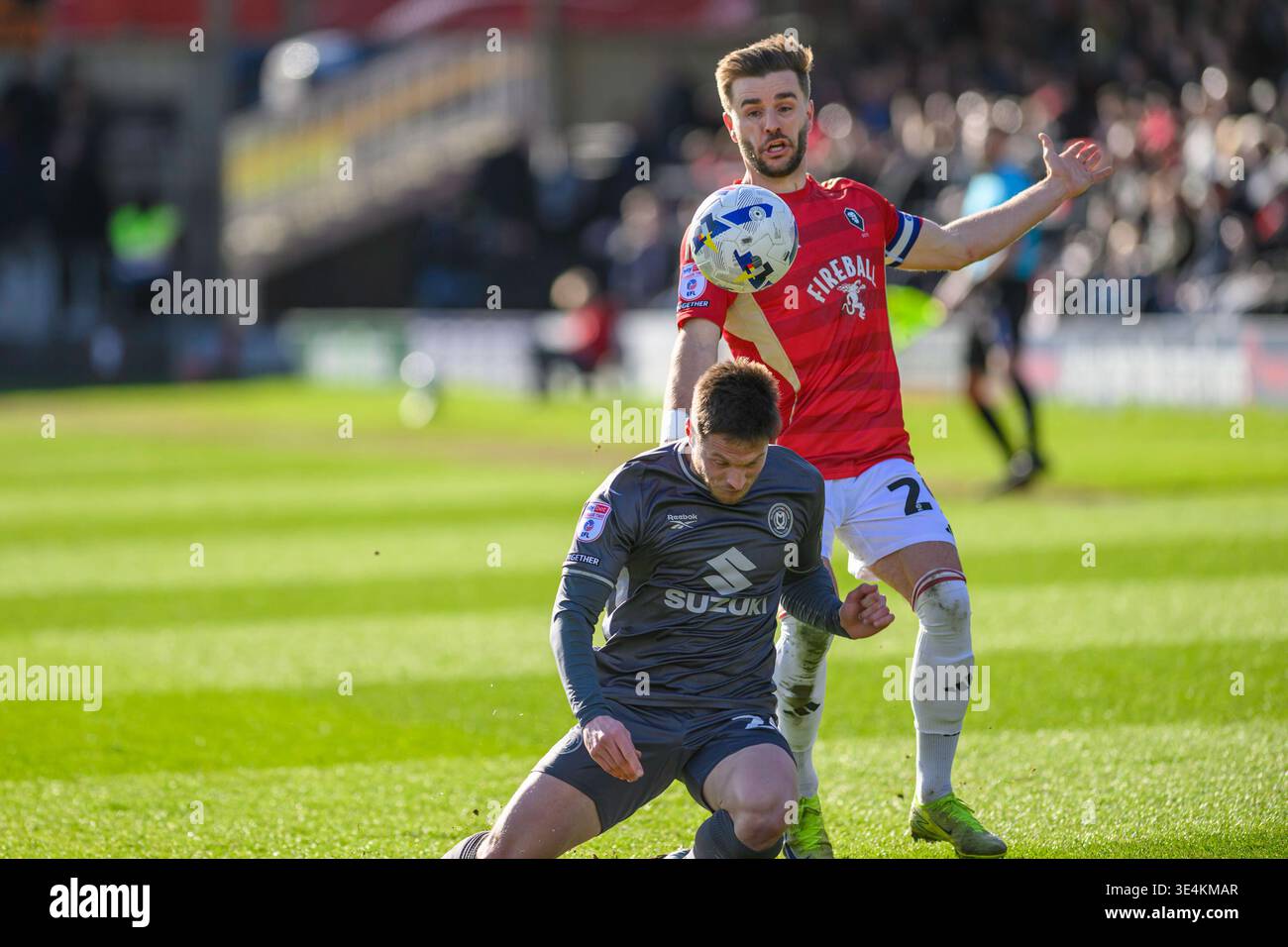 Luke Garbutt of Salford City FC tackles Ben Wiles of Milton Keynes Dons ...