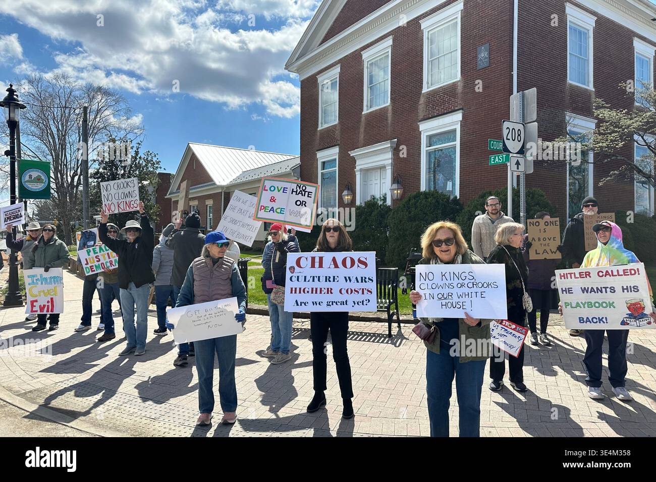 Demonstrators wave signs at drivers during a "No Kings" protest in ...