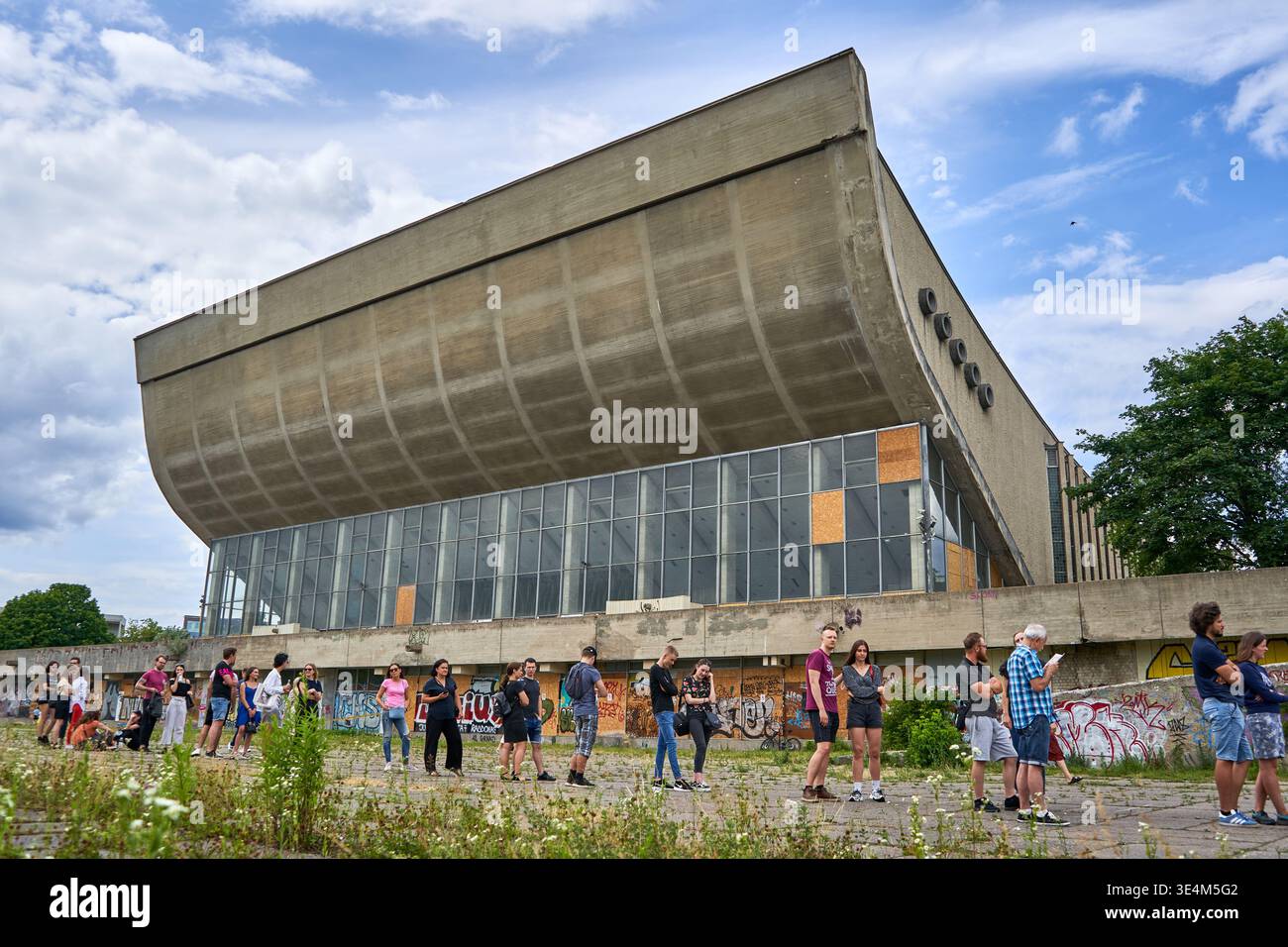 A group of tourists gathers outside the Palace of Concerts and Sports ...