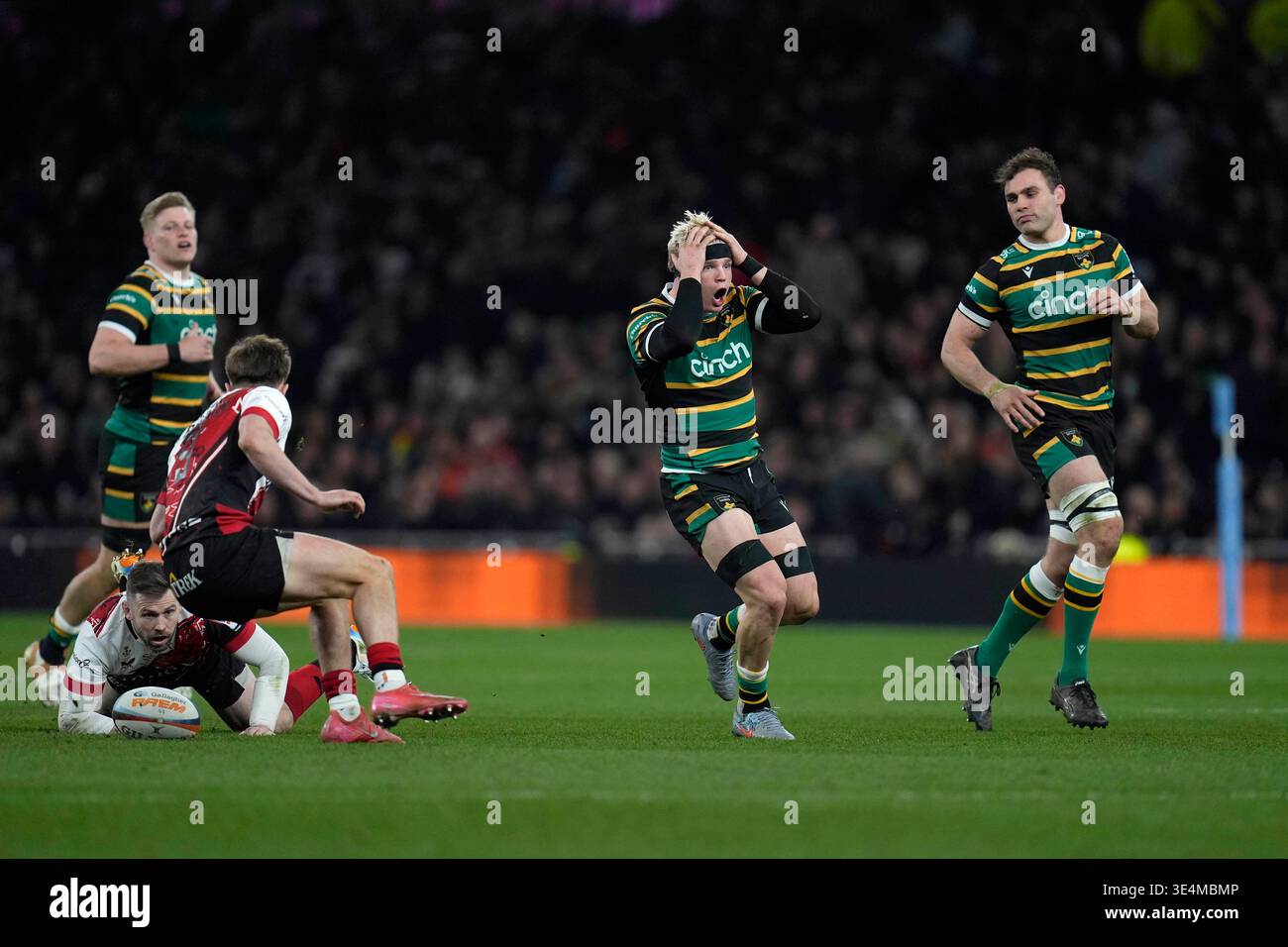 Northampton Saints' Henry Pollock (centre) reacts after missing a pass ...