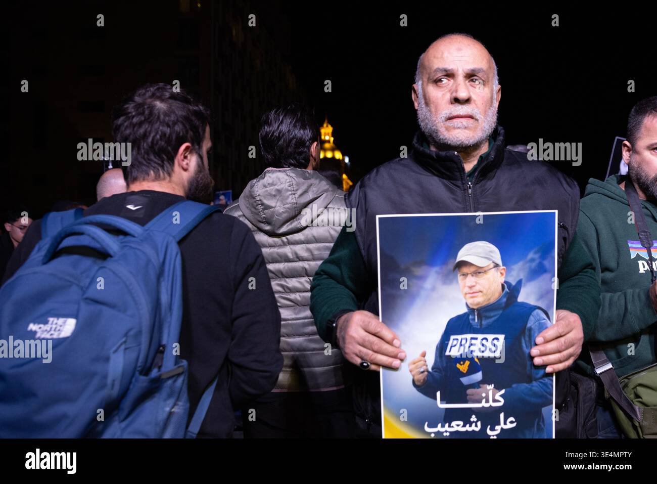 Beirut. 28th Mar, 2026. A man holds a portrait of Al-Manar journalist ...