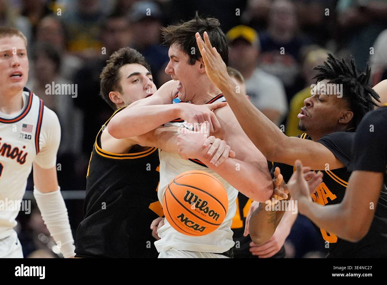 Illinois' David Mirkovic, center is fouled by Iowa's Tate Sage, left ...
