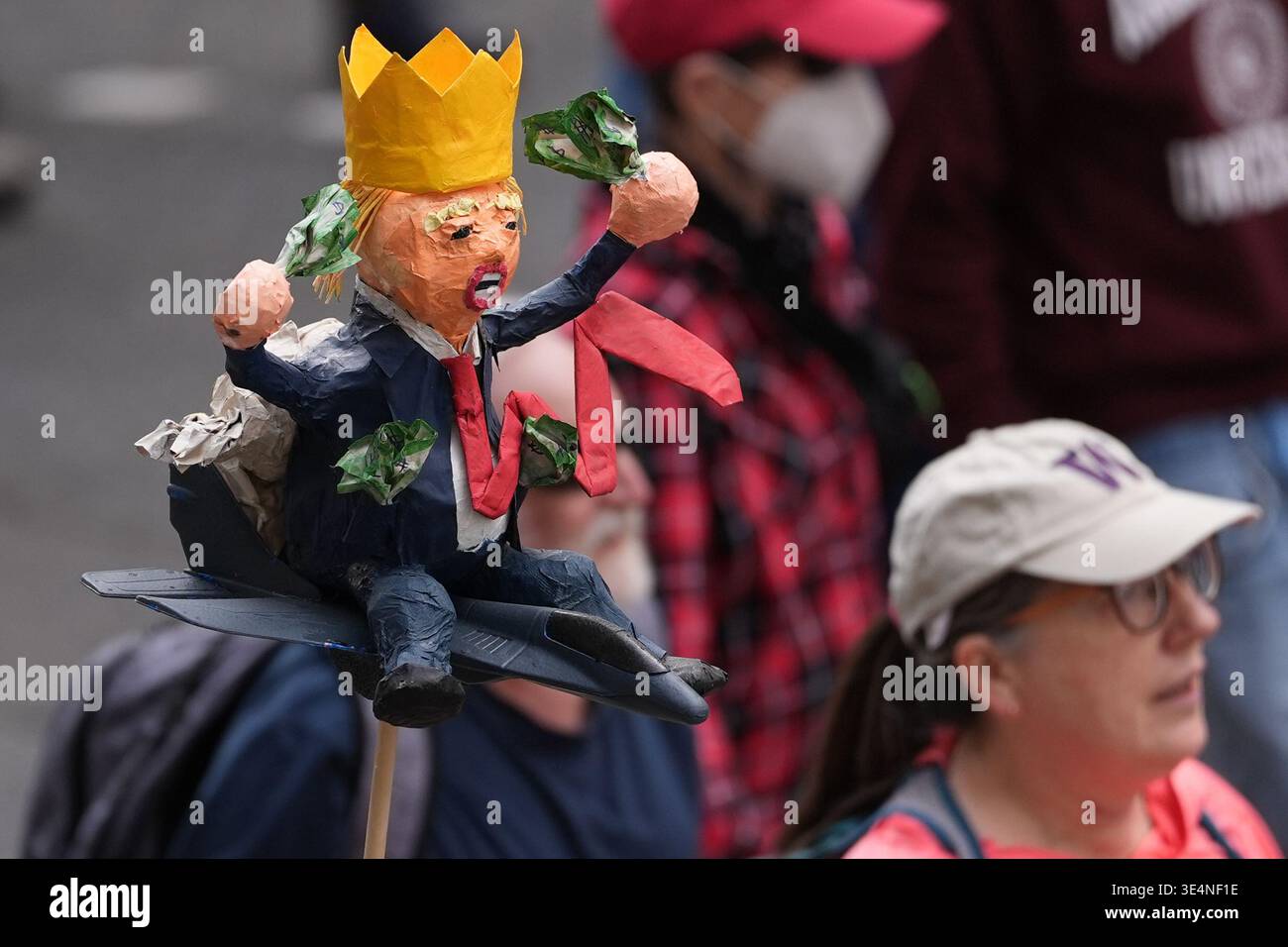 A papier-mache depicting President Donald Trump holding money while ...