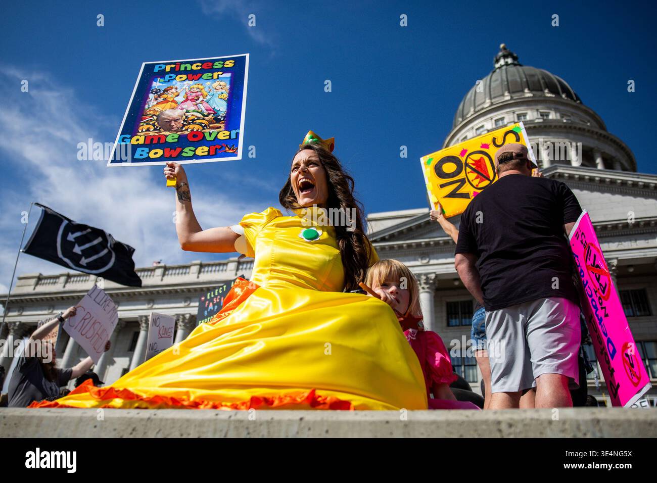 Nicole Kunz, center, sits with her daughter during a "No Kings" anti ...