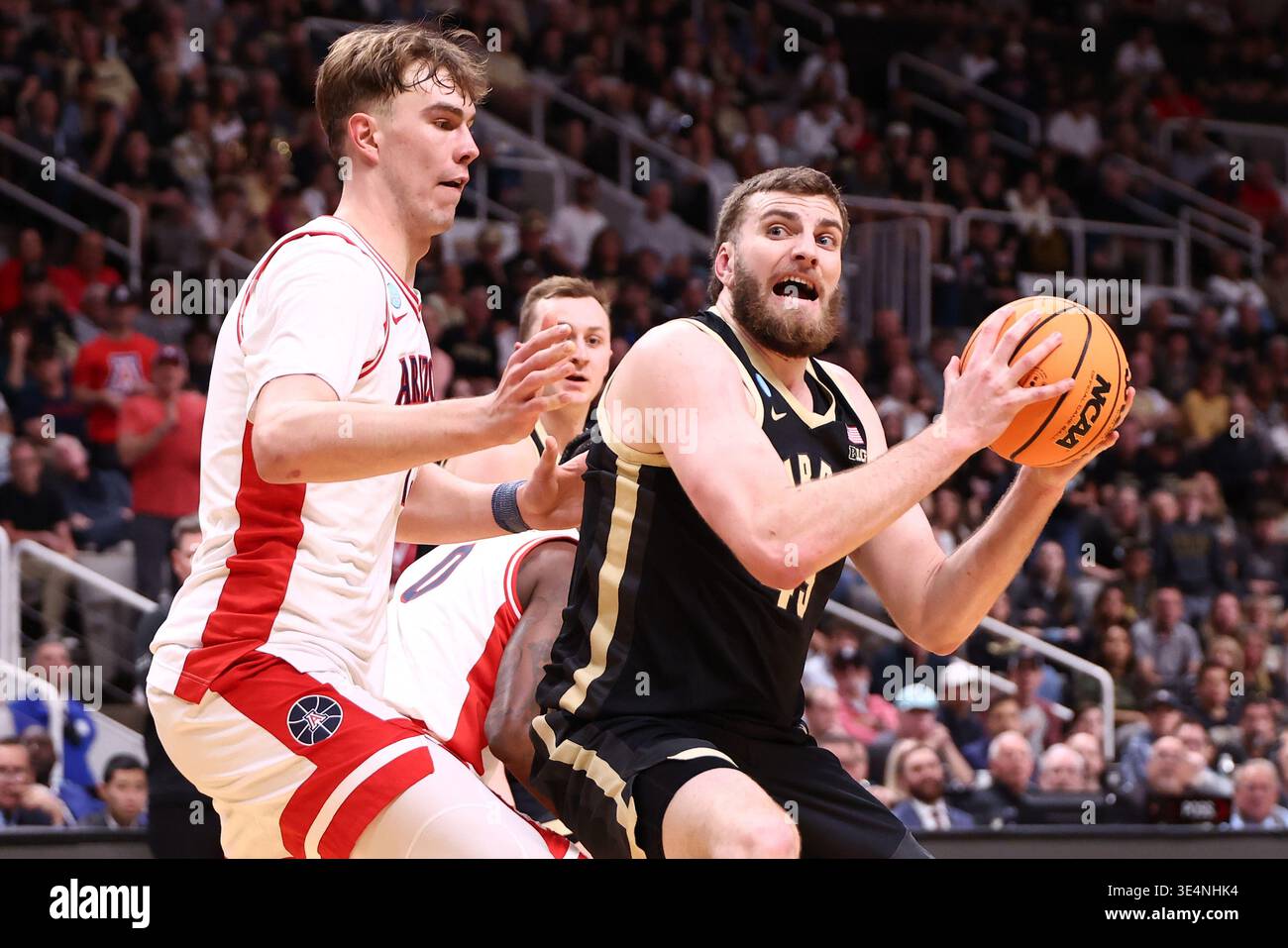 Purdue center Oscar Cluff, right, is defended by Arizona center ...
