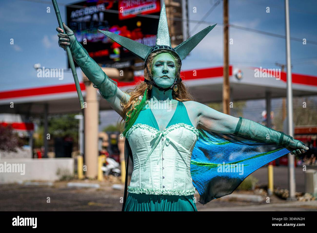 Carrie Chavez, dressed as the Statue of Liberty, participates in a "No ...