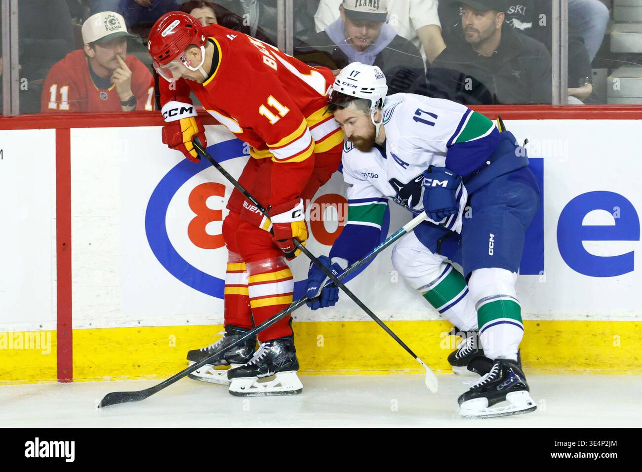 Vancouver Canucks' Filip Hronek (17) runs into Calgary Flames' Mikael ...