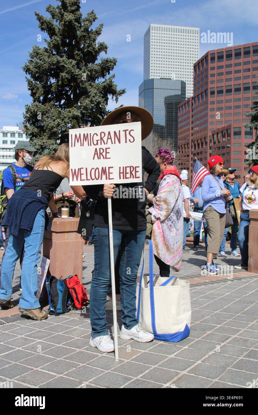 A person props up a sign that reads, Immigrants Are Welcome Here at the ...
