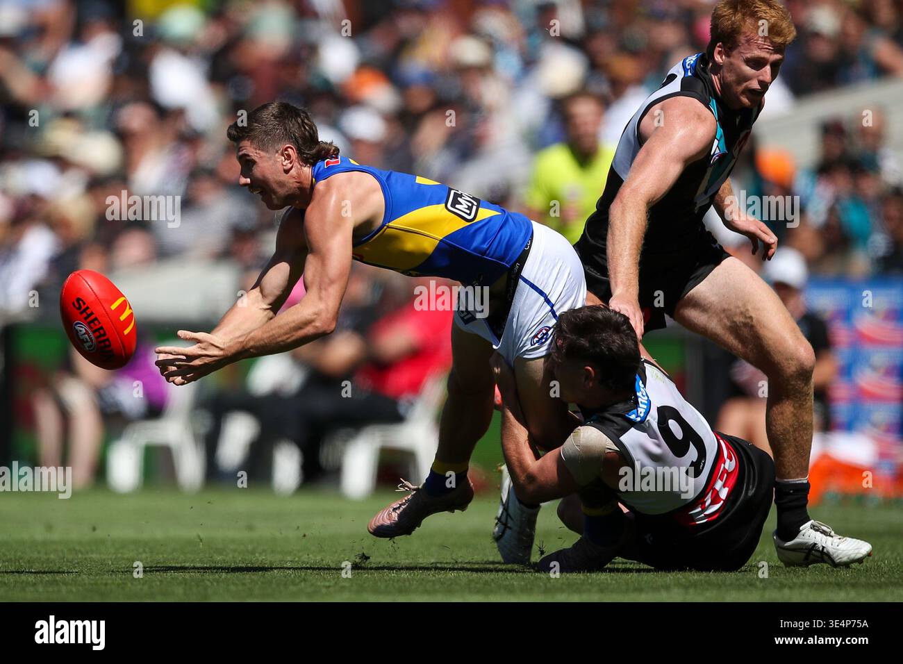 Liam Baker of the Eagles is tackled by Zak Butters and Willem Drew of ...