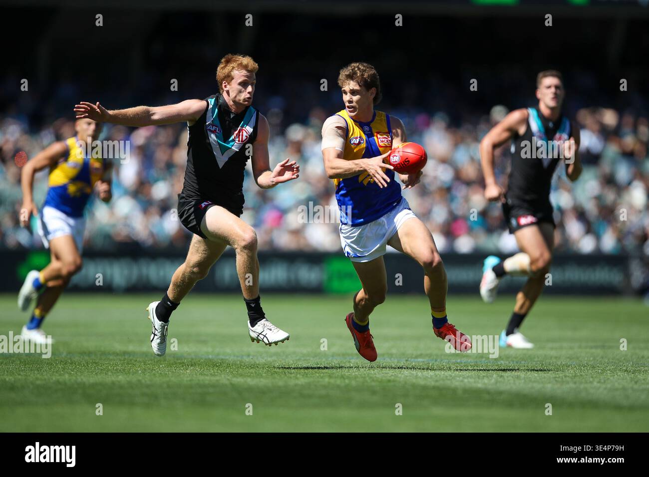 Deven Robertson of the Eagles chased by Willem Drew of the Power during ...