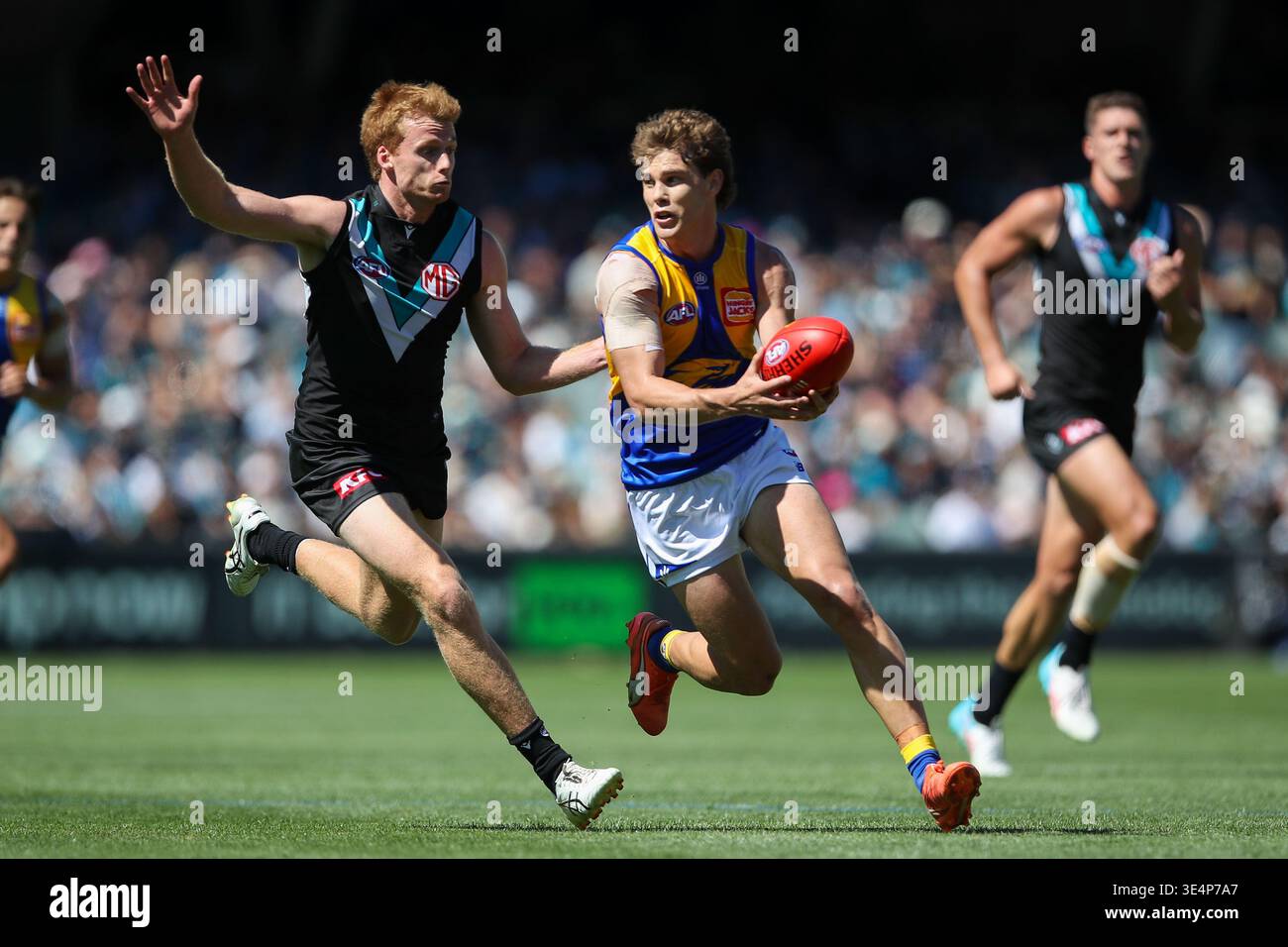 Deven Robertson of the Eagles chased by Willem Drew of the Power during ...