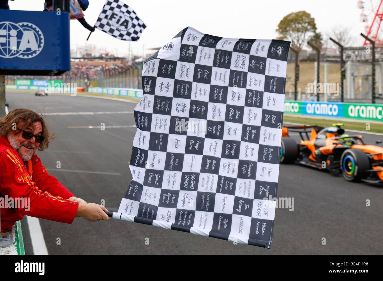 U.S. actor Jack Black waves the checkered flag as McLaren driver Oscar ...