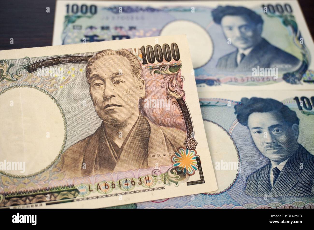 A Japanese 10,000-yen banknote with Fukuzawa Yukichi in the foreground ...