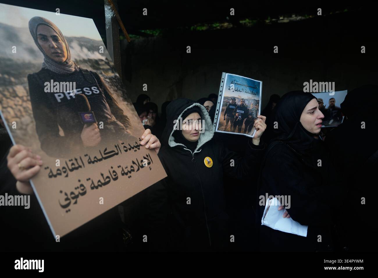 Women hold posters showing Al-Mayadeen TV reporter Fatima Ftouni, left ...