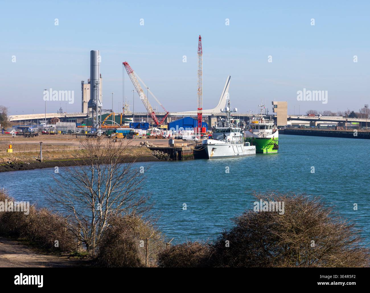 Cranes port equipment, Lowestoft, Suffolk, England, UK Green boat is ...