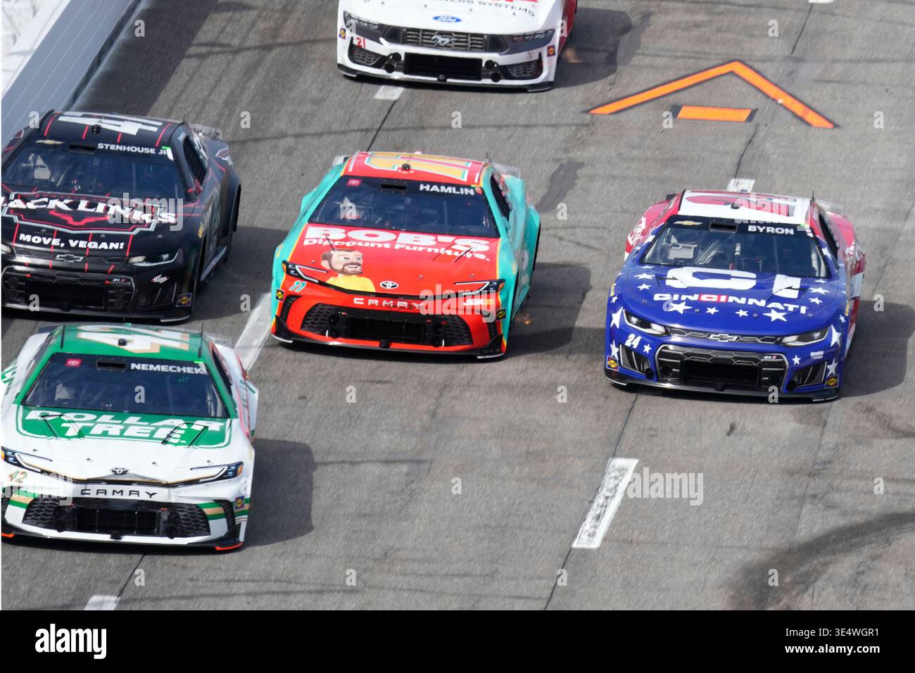 William Byron (24) battles Denny Hamlin (11) for the lead as they pass ...