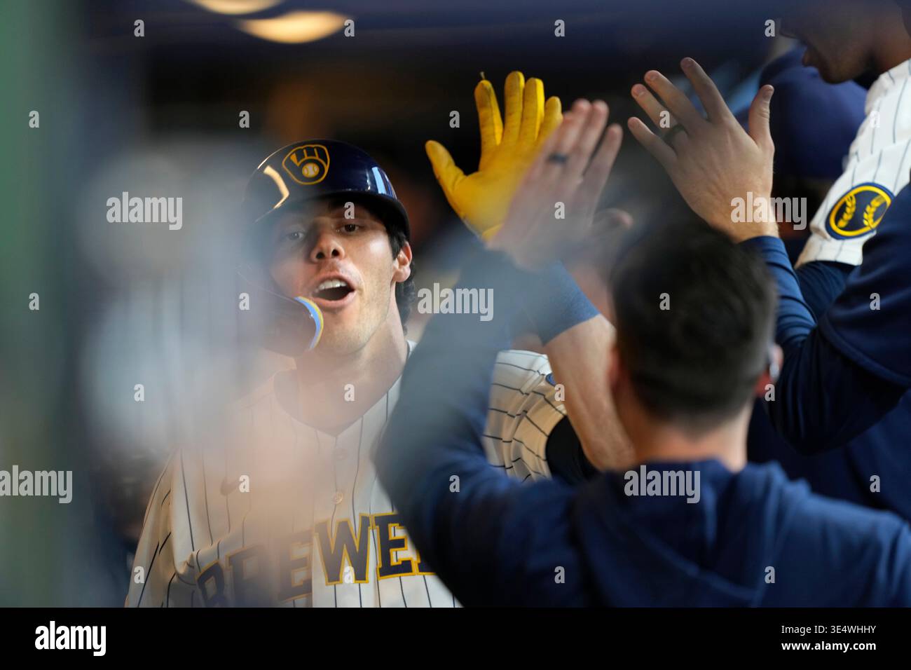 Milwaukee Brewers' Christian Yelich high-fives teammates after hitting ...