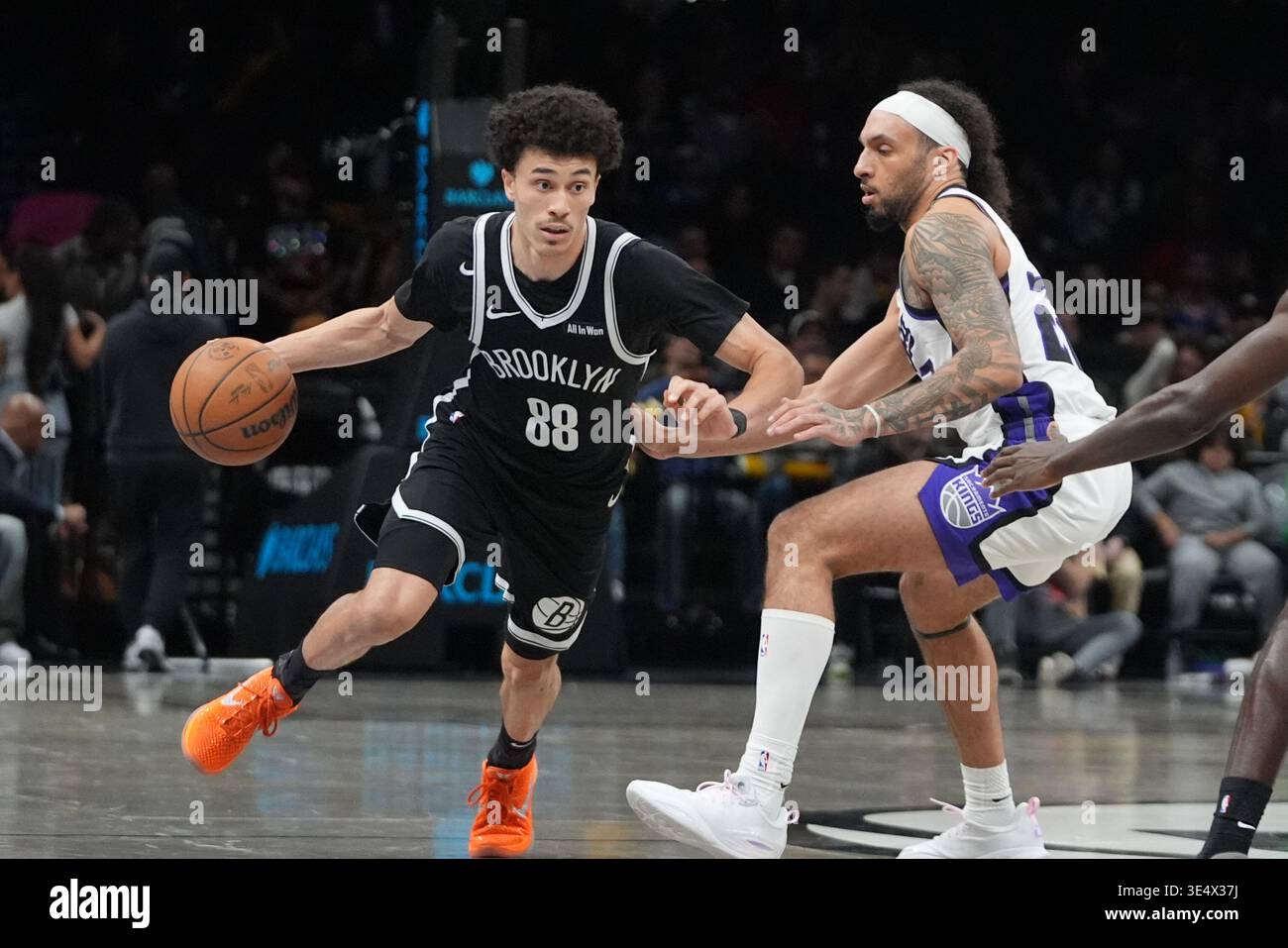 Brooklyn Nets' Nolan Traore (88) drives past Sacramento Kings' Devin ...