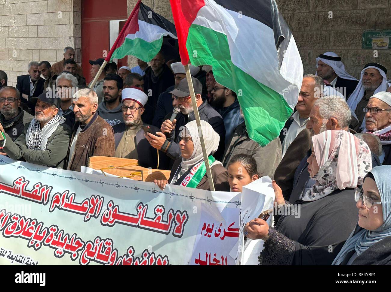 Palestinians participate in a vigil in front of the Red Cross ...
