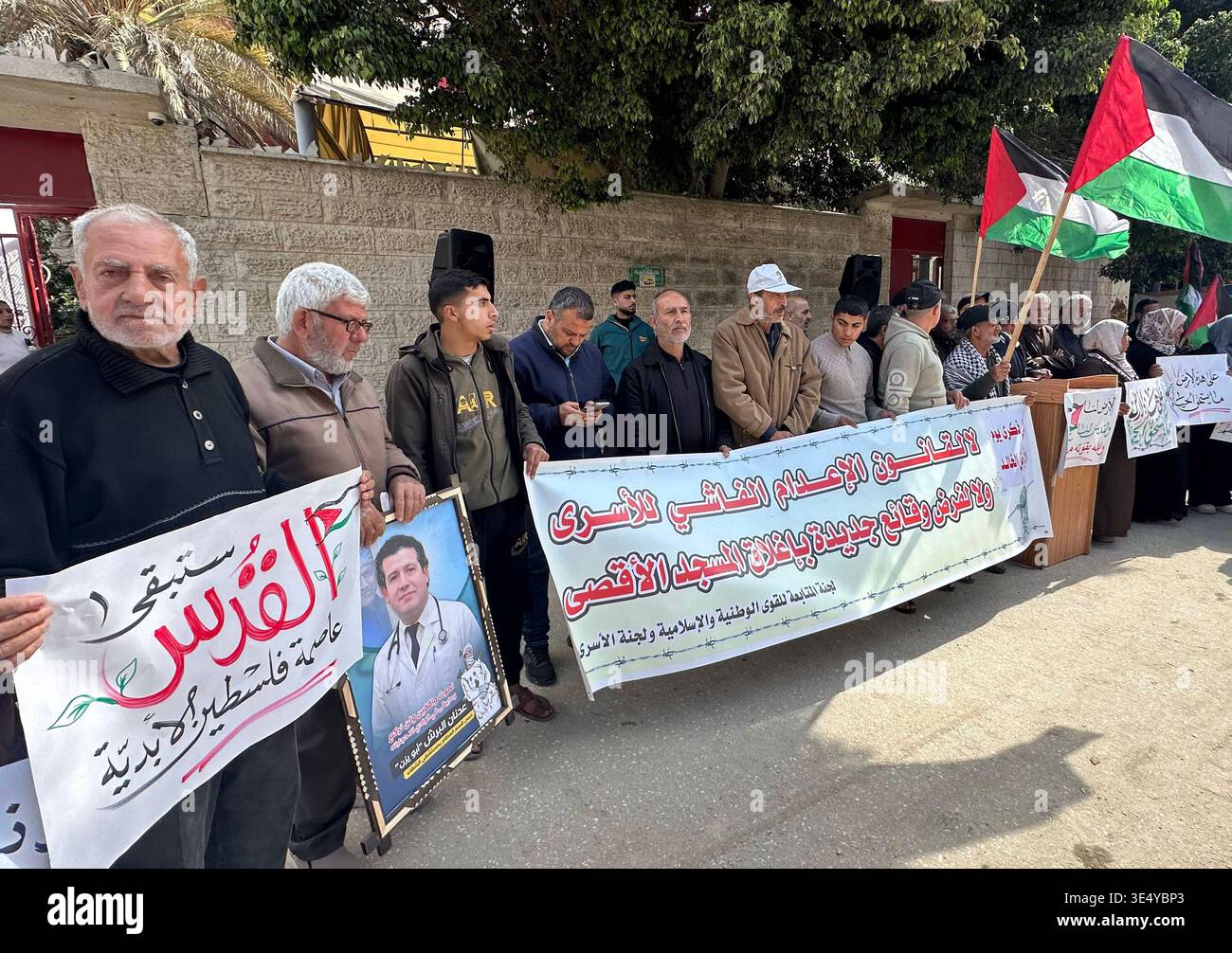 Palestinians participate in a vigil in front of the Red Cross ...
