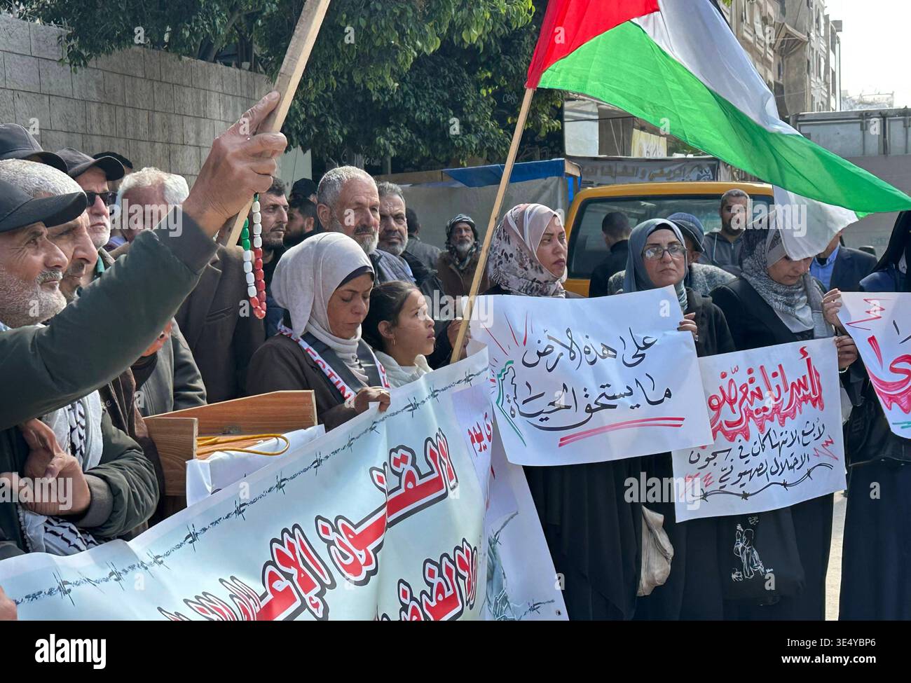 Palestinians participate in a vigil in front of the Red Cross ...