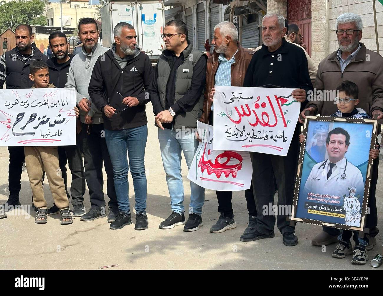 Palestinians participate in a vigil in front of the Red Cross ...