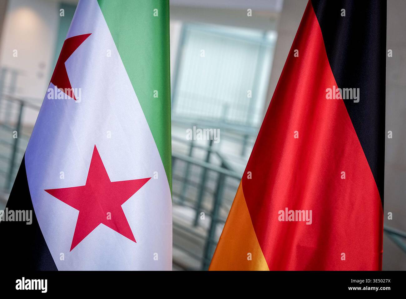 30 March 2026, Berlin: The Syrian flag hangs next to the German flag in ...
