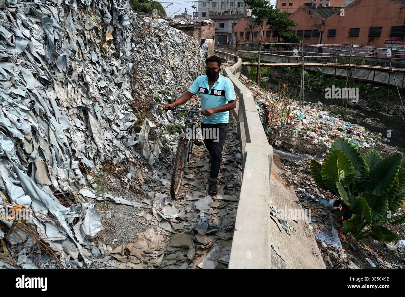 March 30, 2026, Dhaka, Dhaka, Bangladesh: People walk past piles of ...
