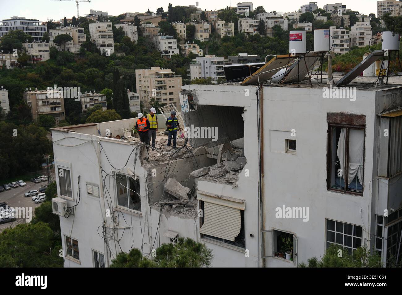 Israeli authorities inspect a damaged house following an Iranian ...