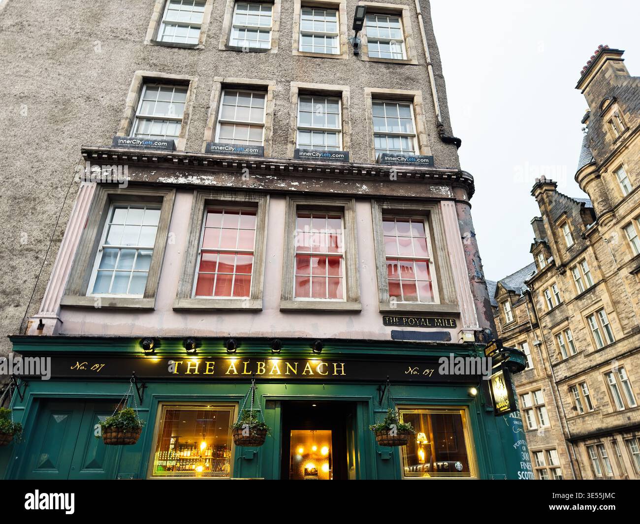 Edinburgh, Scotland, UK - February 15, 2026: Warm lit traditional The ...