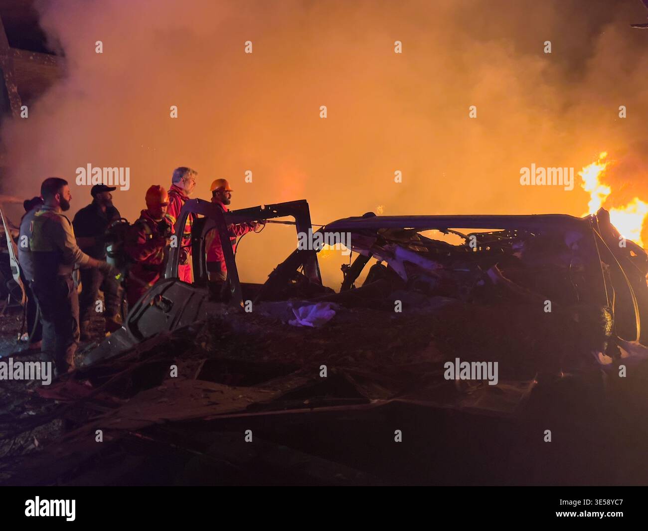 Firefighters and rescue workers inspect the site of Israeli airstrikes ...