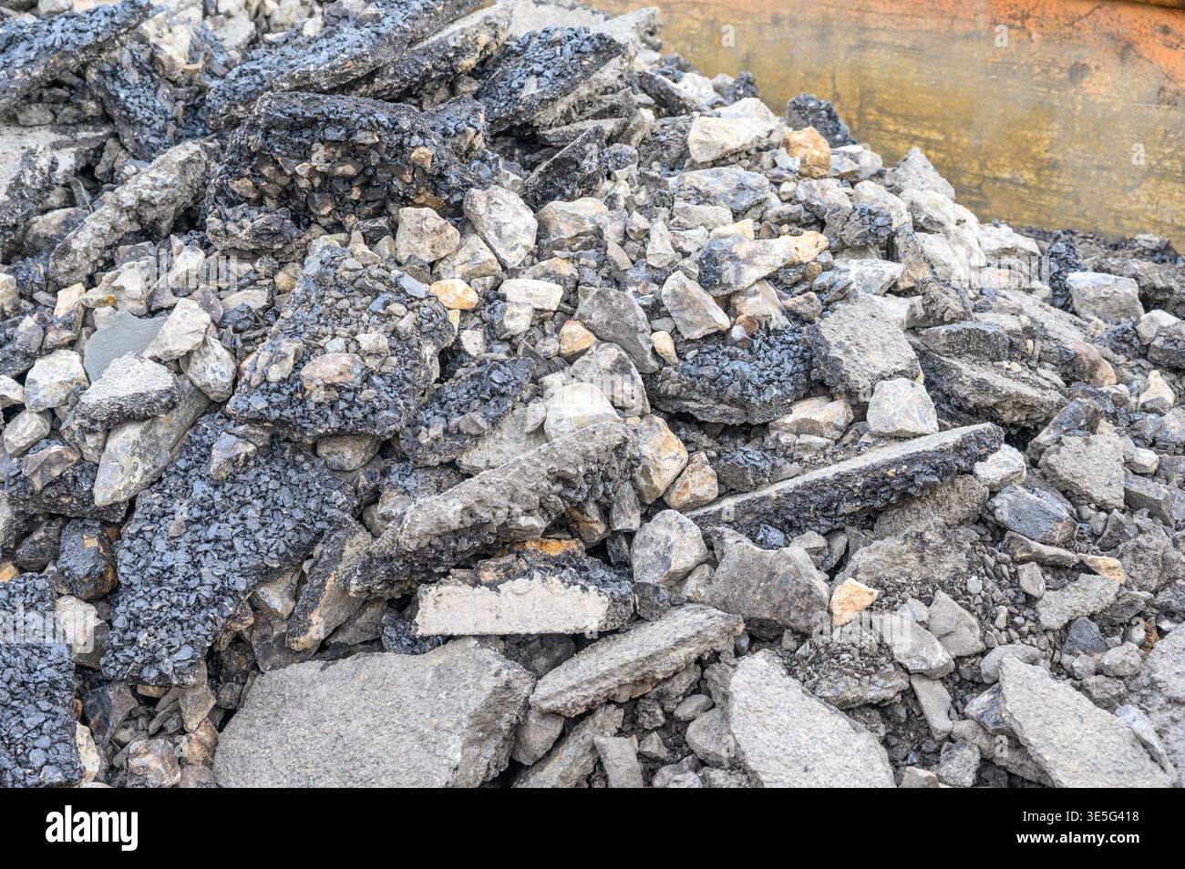 Pile of broken asphalt and concrete rubble from road construction ...