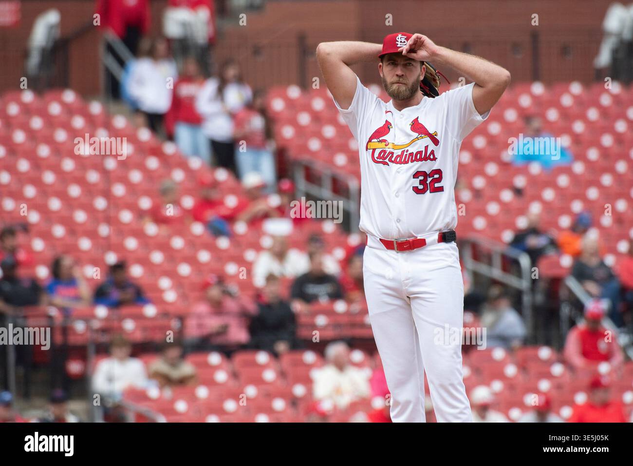 St. Louis Cardinal pitcher Matthew Liberatore straightens his cap in a ...